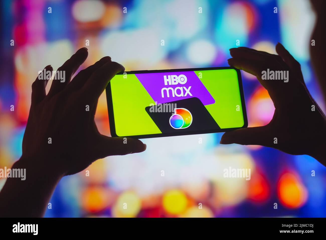 In this photo illustration, the HBO Max and Discovery Plus logos is ...