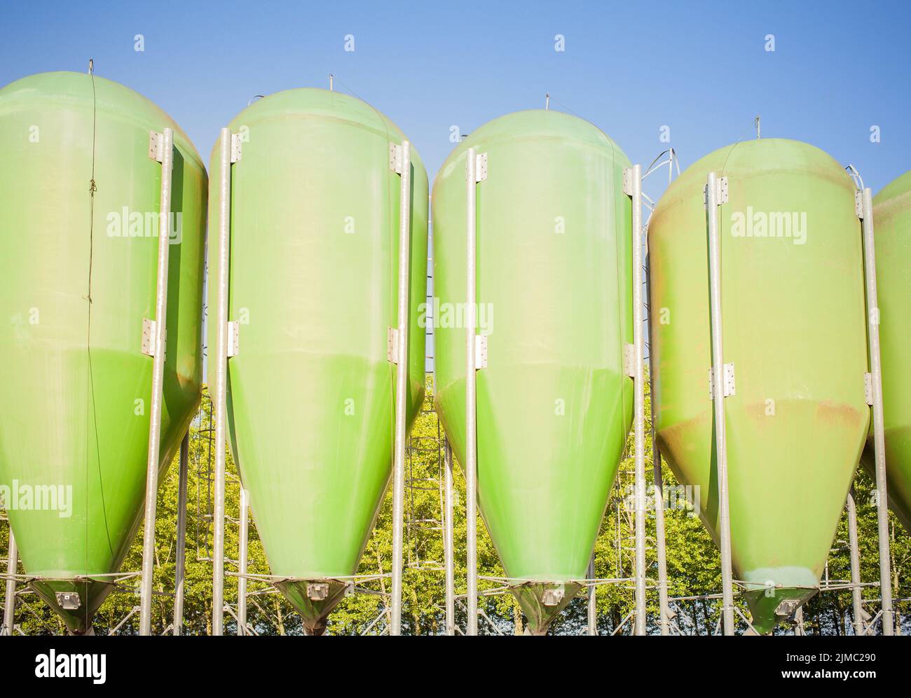Agricultural green silos Stock Photo - Alamy