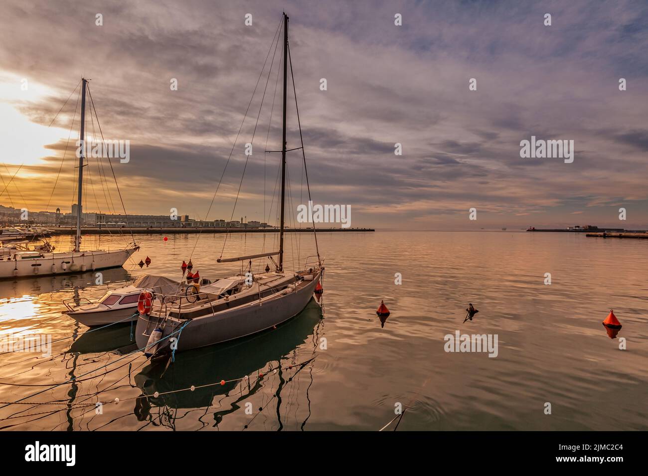 Pleasure boats moored in harbor Stock Photo - Alamy