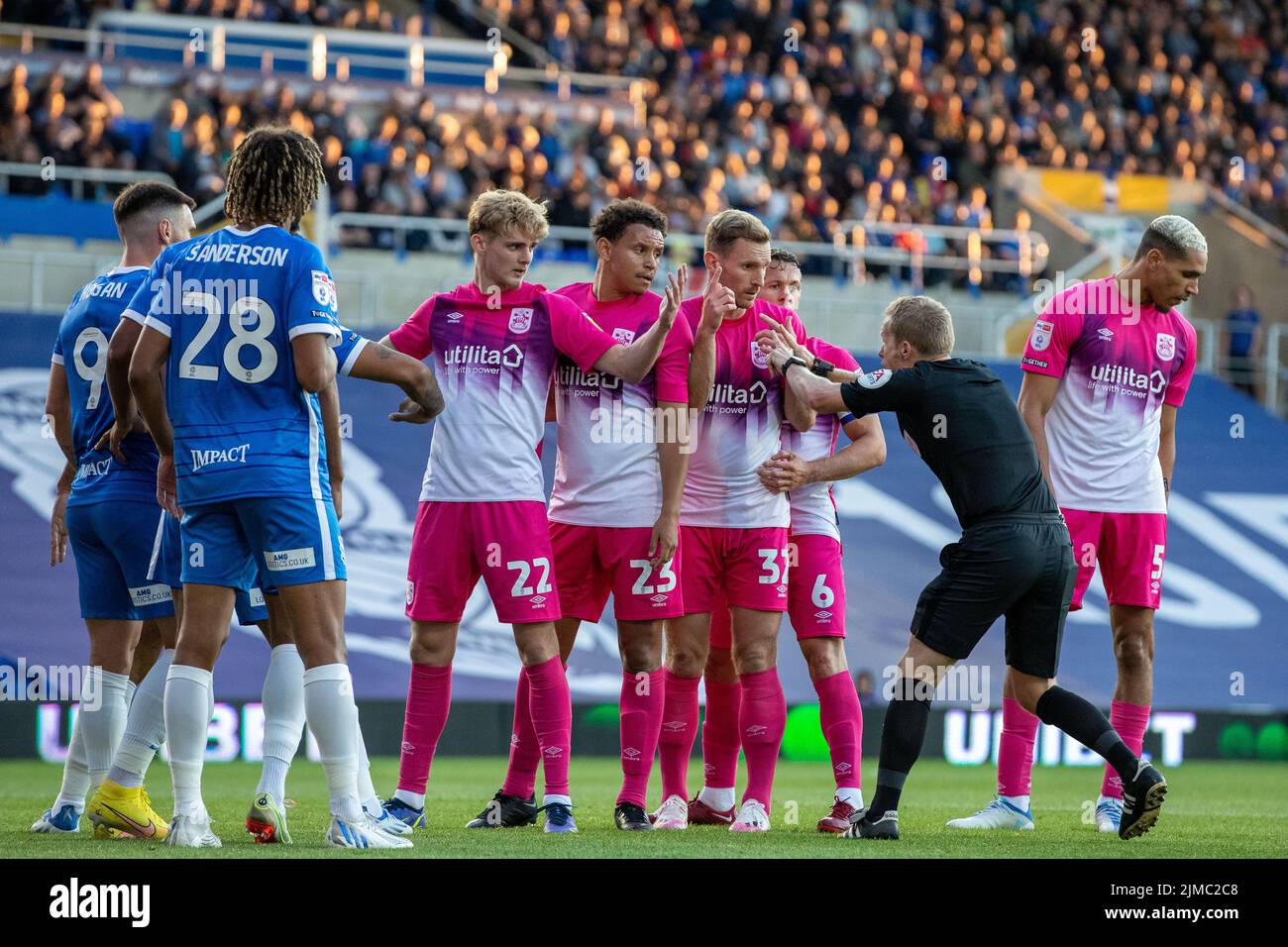 Referee Gavin Ward tells the Huddersfield Town players to stay where ...