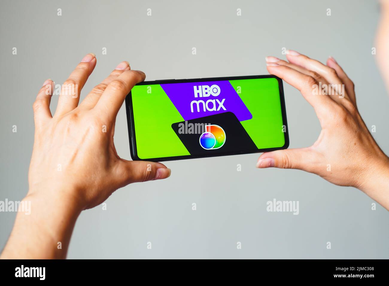 In this photo illustration, the HBO Max and Discovery Plus logos is ...