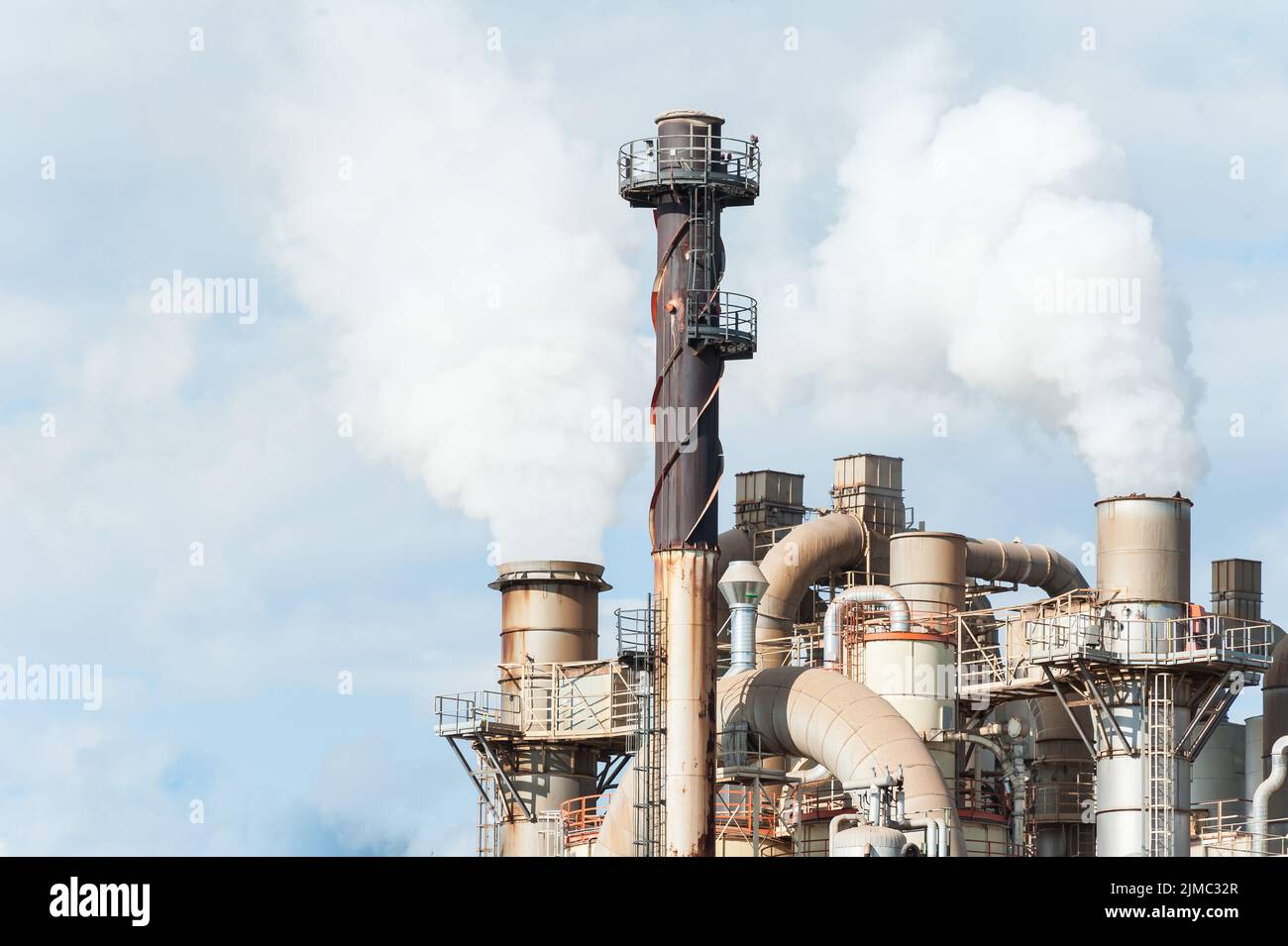 Industrial plant of a furniture factory with smoking smokestacks Stock ...