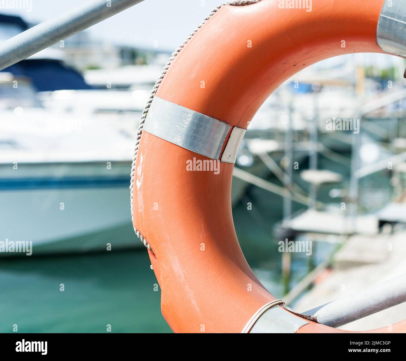 Life buoy hung on a railing in the port Stock Photo - Alamy