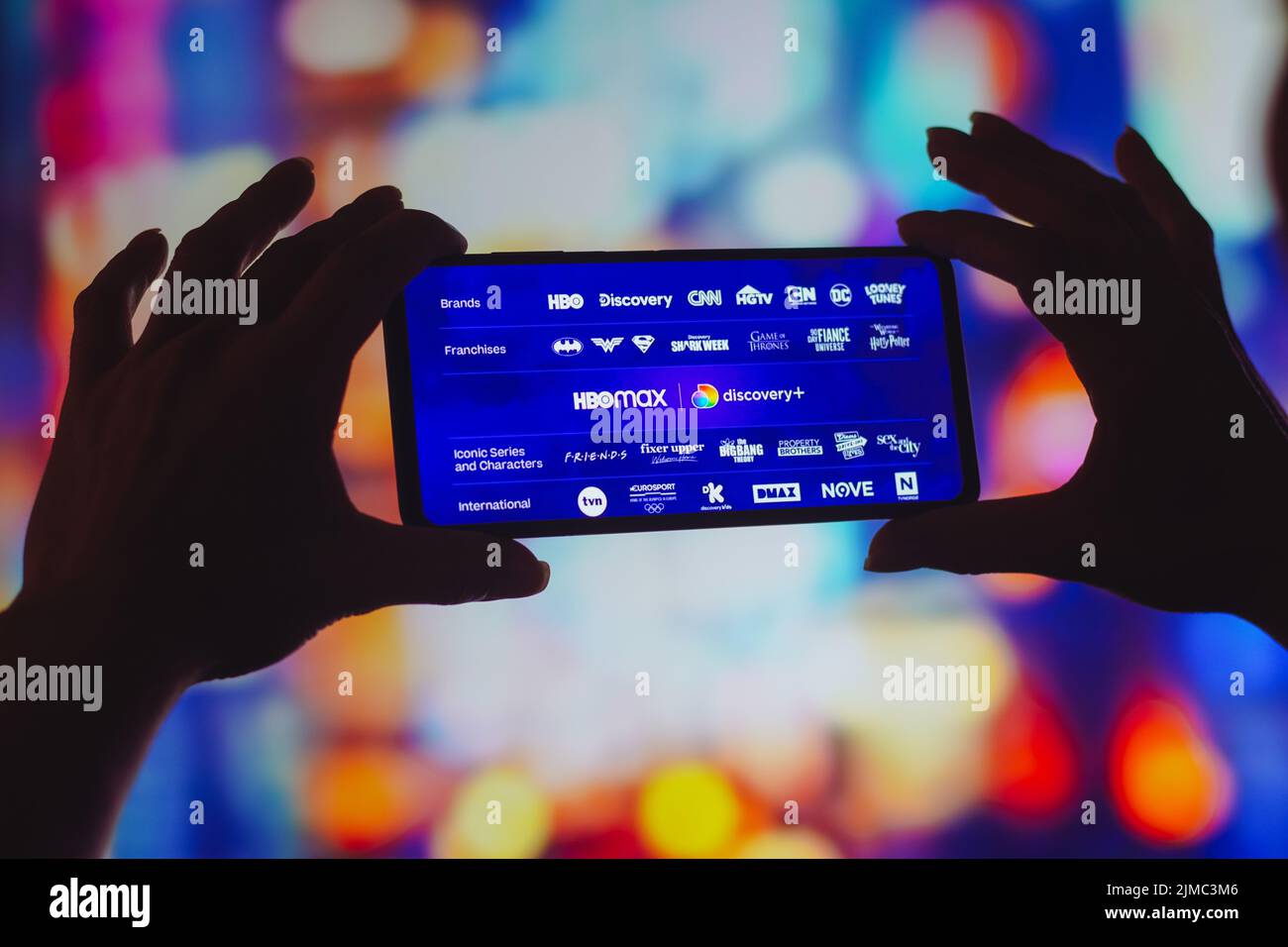 In this photo illustration, the HBO Max and Discovery Plus logos is displayed on a smartphone ...