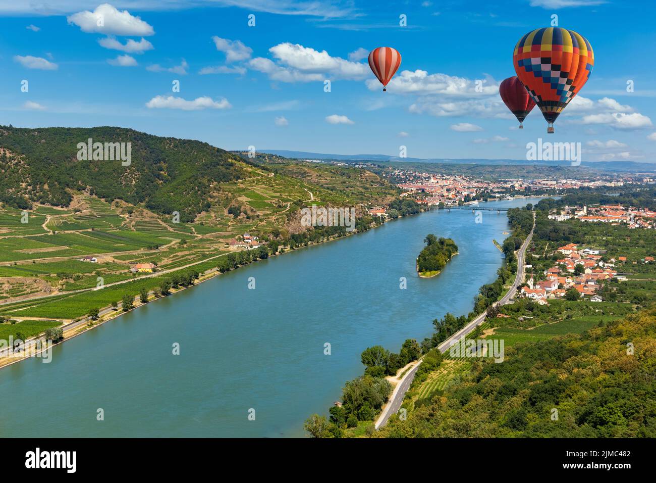 Hot air balloons in the sky over the Danube river in the Wachau valley ...