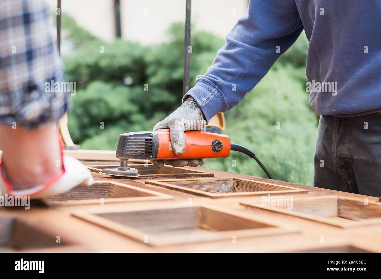 Carpenter at work with angular Sander Stock Photo - Alamy