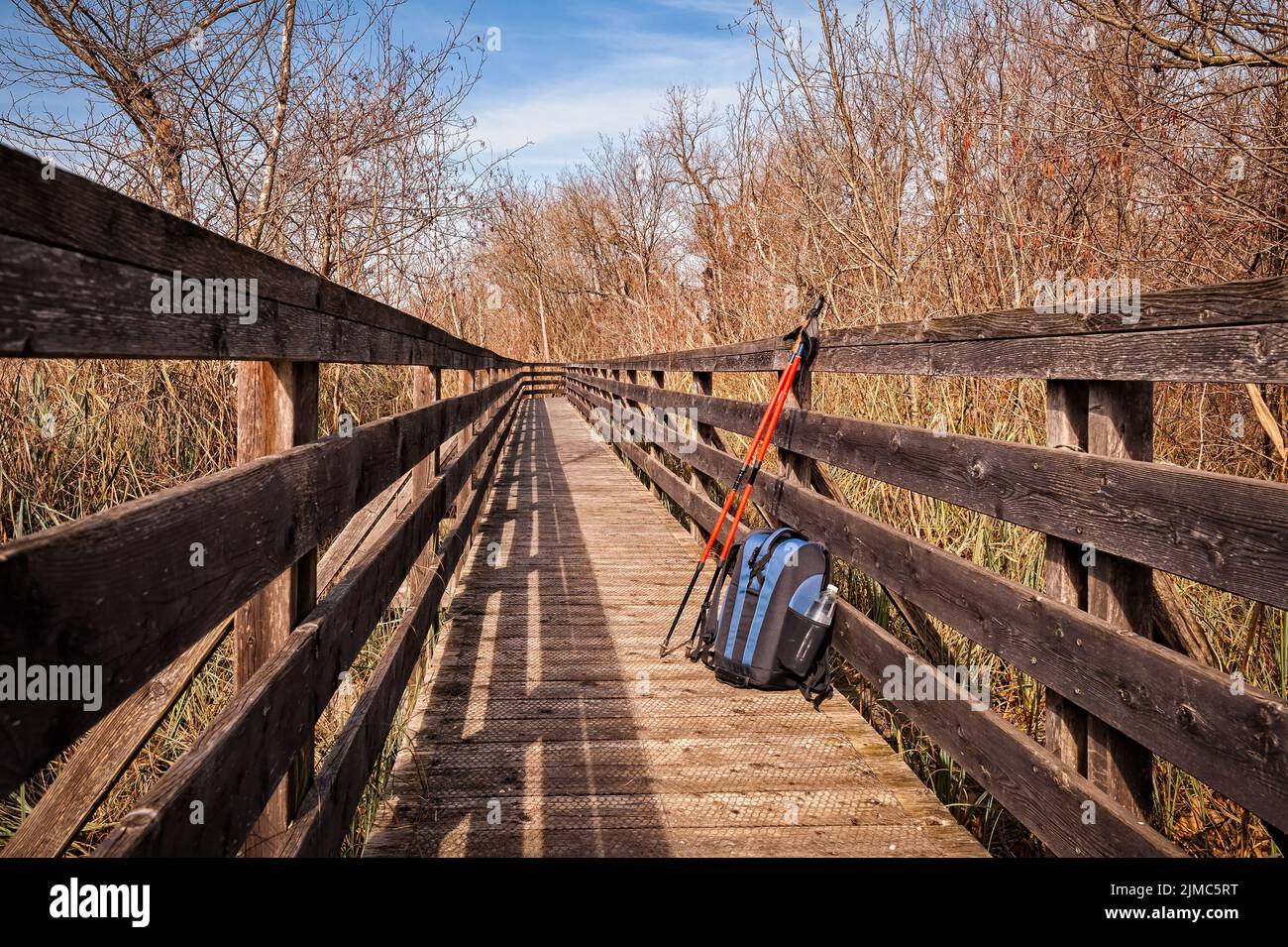 Wooden footbridge for hiking in nature with backpack and poles Stock ...