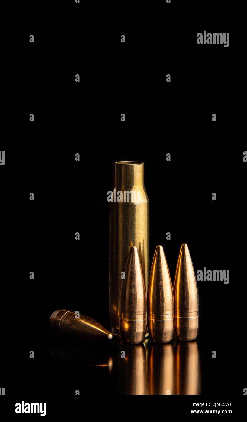 Bullet isolated on black background with reflexion. Rifle bullets close ...