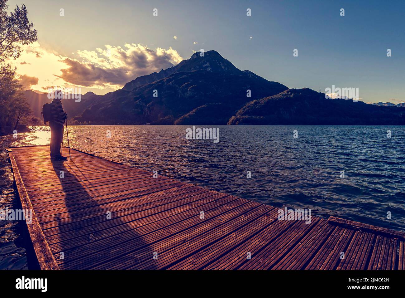 Person looking over water at sunset hi-res stock photography and images ...