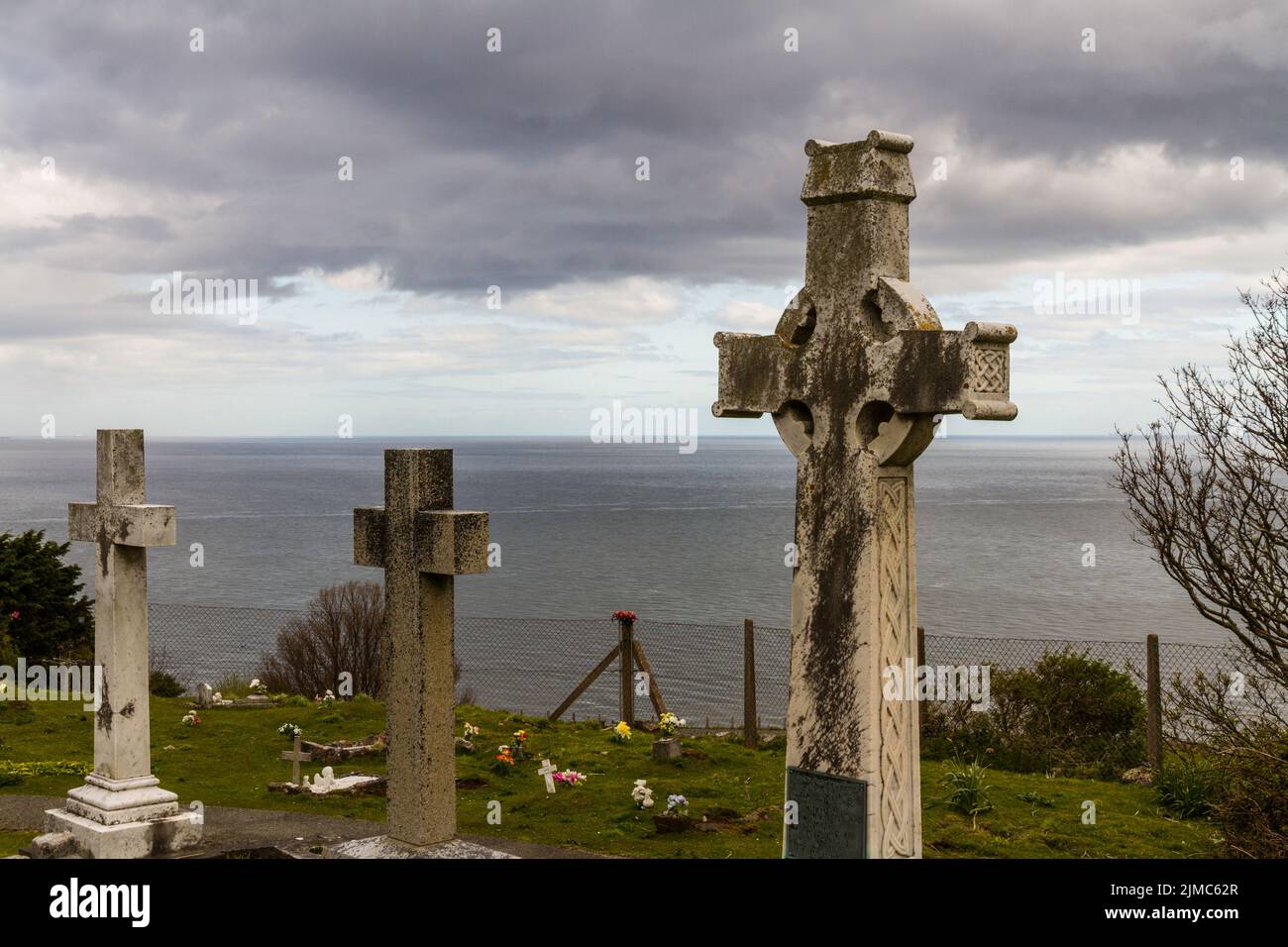 Graves in cemetery with sea, sky with cloud behind Stock Photo - Alamy