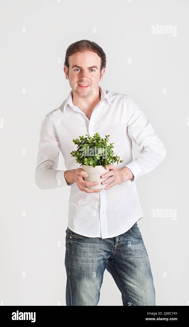 Young man with plant Stock Photo - Alamy