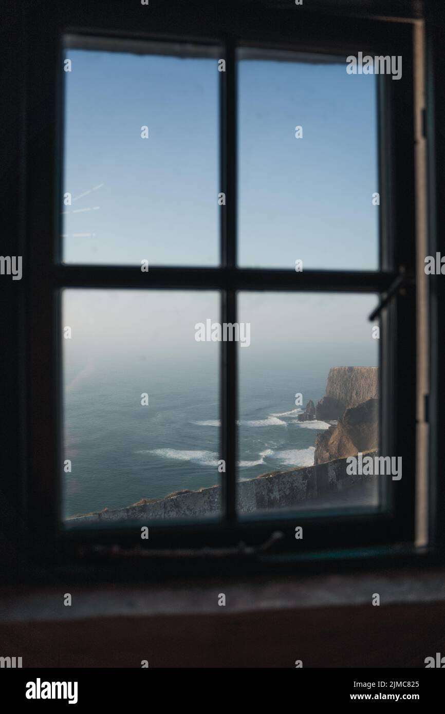A vertical shot of a view of the rocky seashore from a window Stock ...