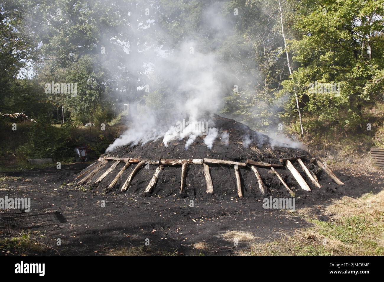 Smoking charcoal kiln Stock Photo - Alamy