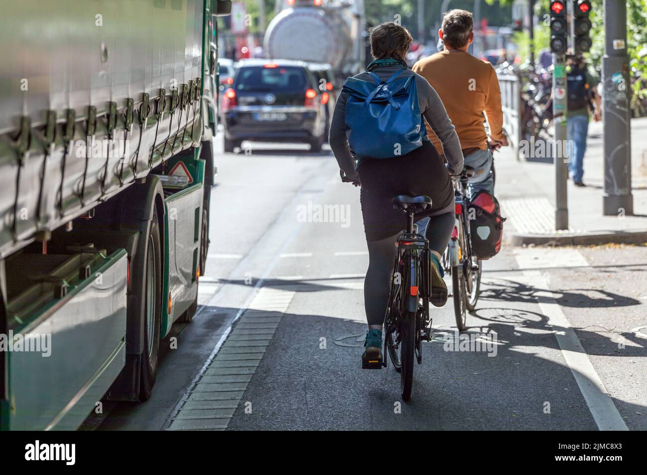 truck overtakes cyclist on bike lane Stock Photo - Alamy
