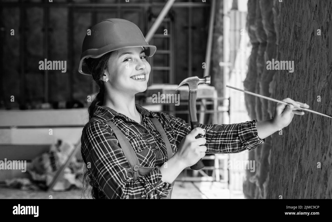 cheerful child laborer using building uniform and hammer tool, labor ...