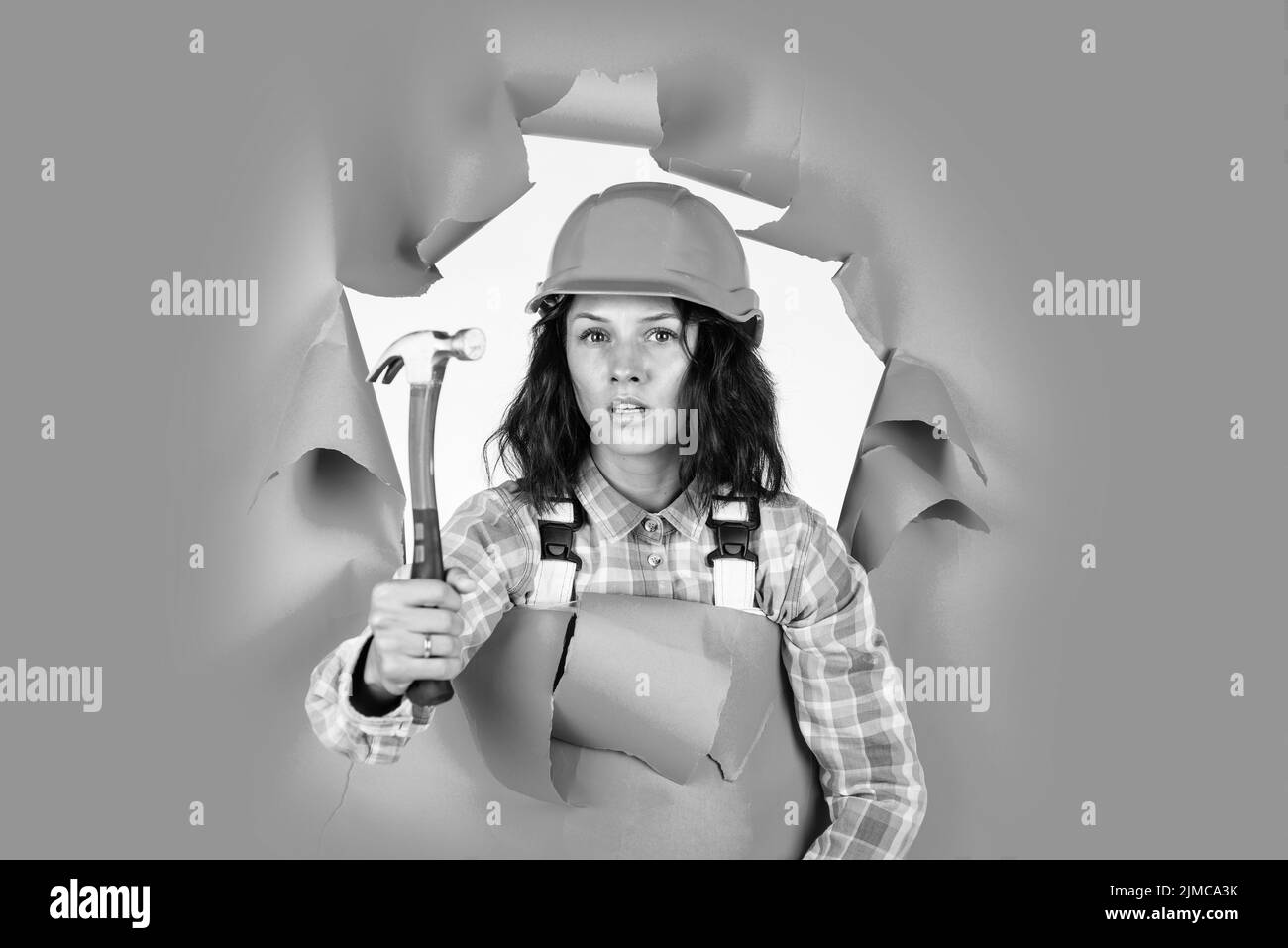 builder assistant repair and fix. female worker in working uniform ...