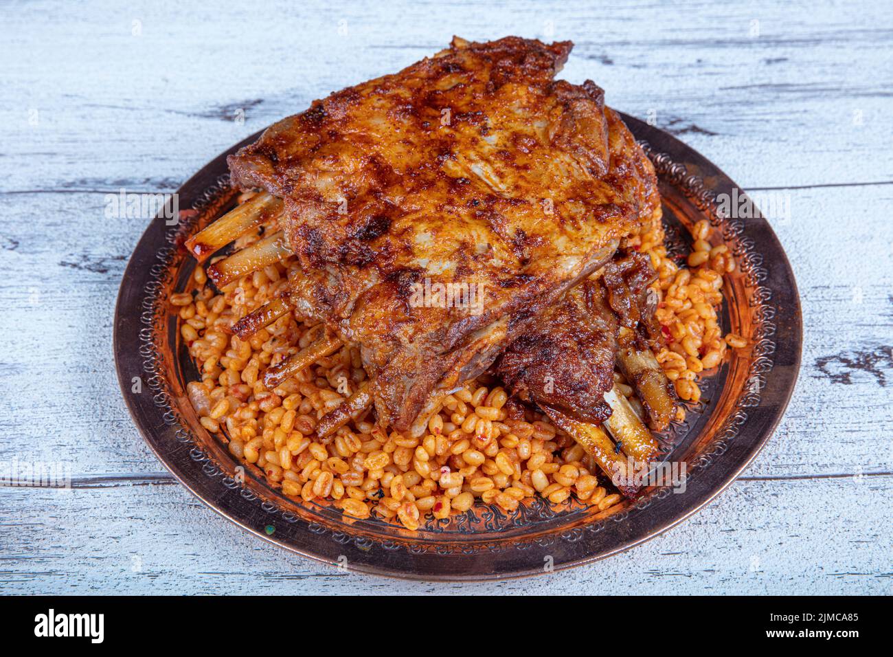Lamb ribs on bulgur pilaf. Stuffed Ribs isolated on black background ...