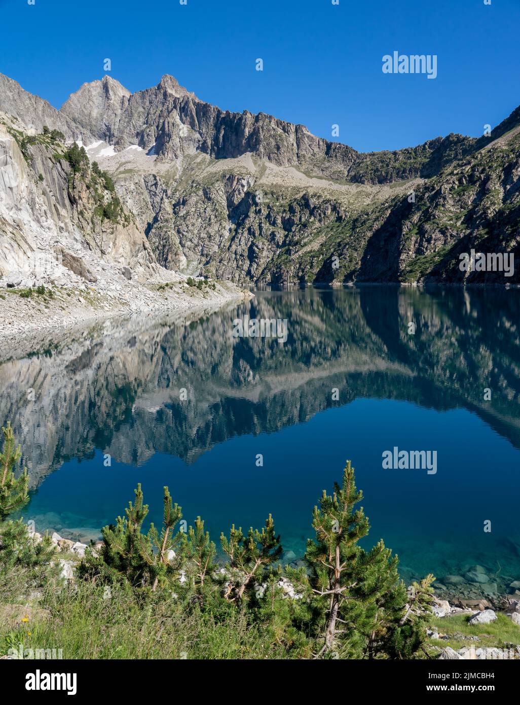 mountain reflection in still blue water lake, Lac de Cap-de-Long ...