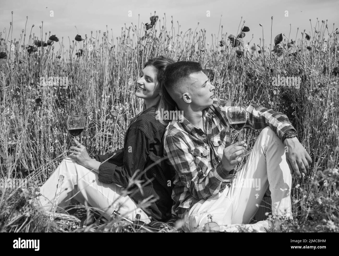 Guy And Girl Having Romantic Date In Poppy Flower Field With Guitar Music And Wine Date Stock 7666