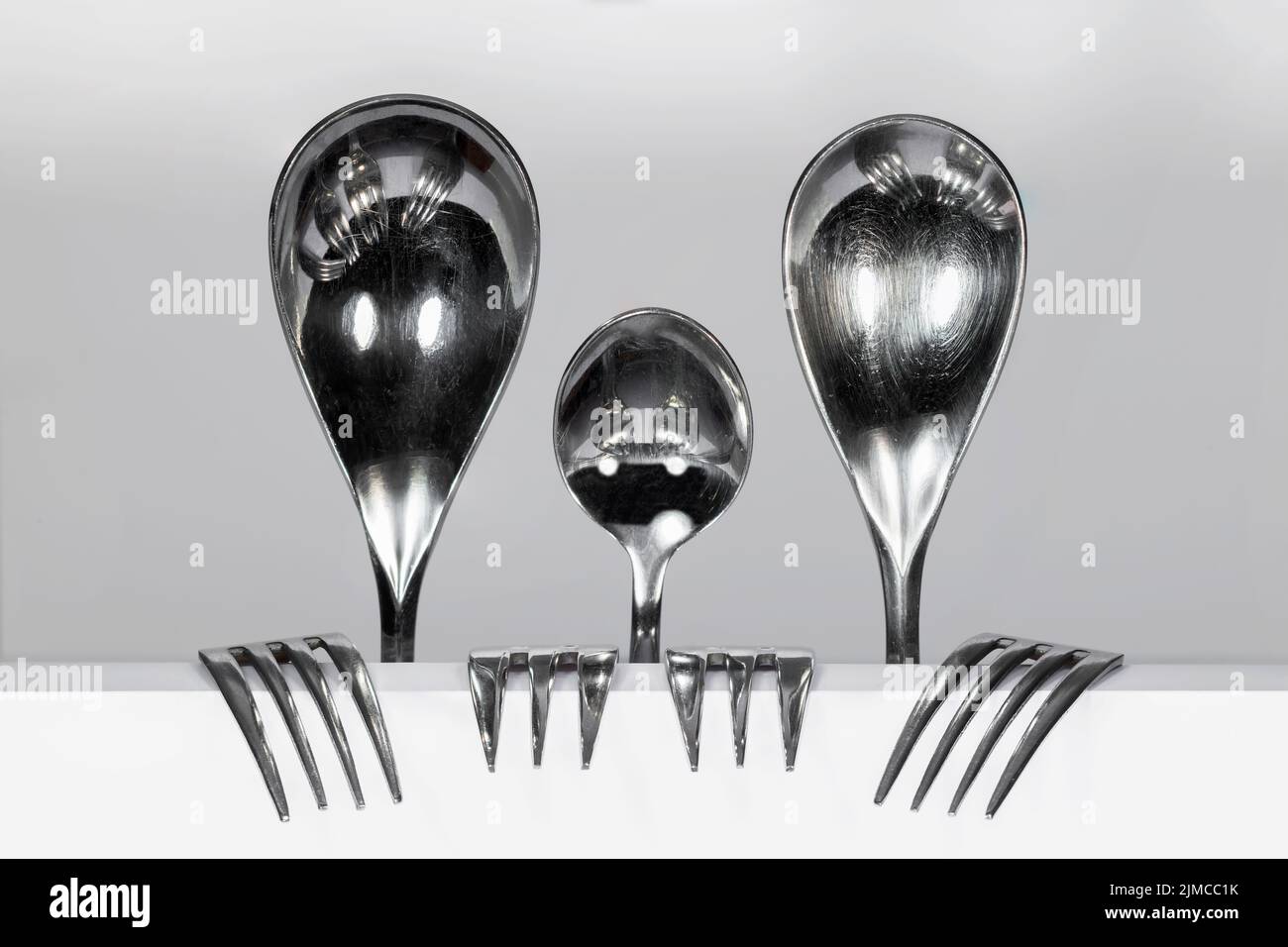 Cutlery Family of three spoons and four forks Stock Photo - Alamy