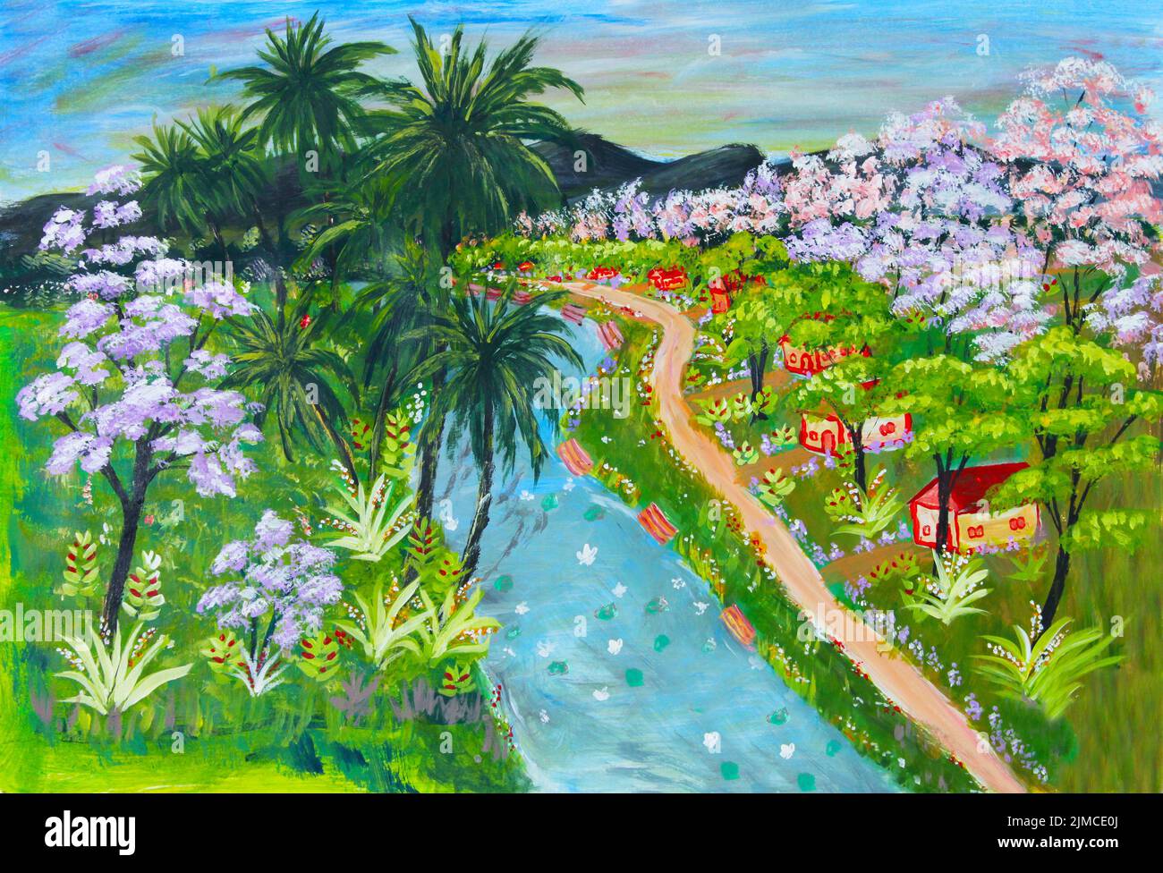 Small rural village huts and homes along a flowing river in a tropical ...