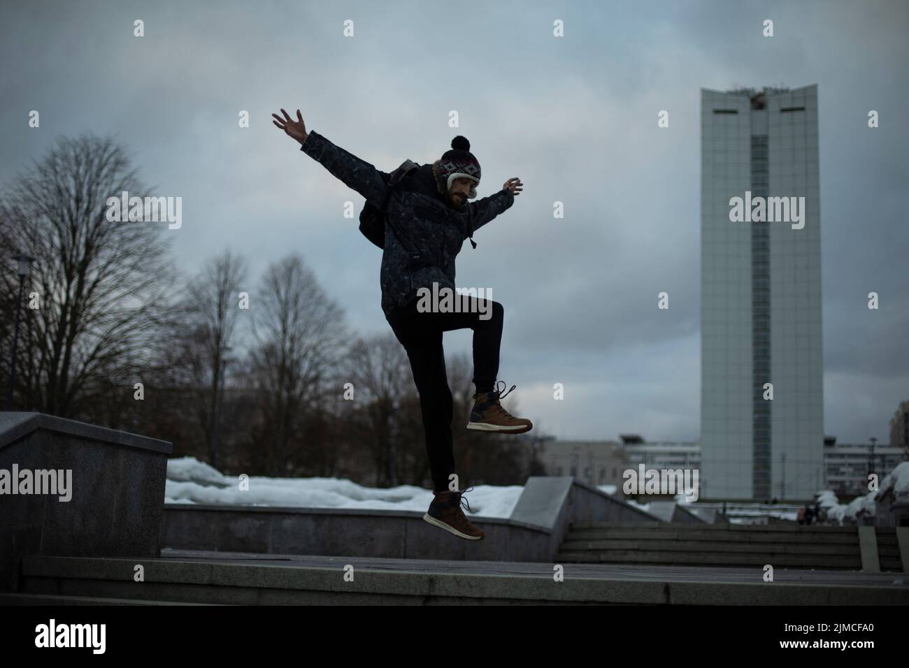 Guy jumps. Man flies from above. Man in front of tower. Spontaneous ...