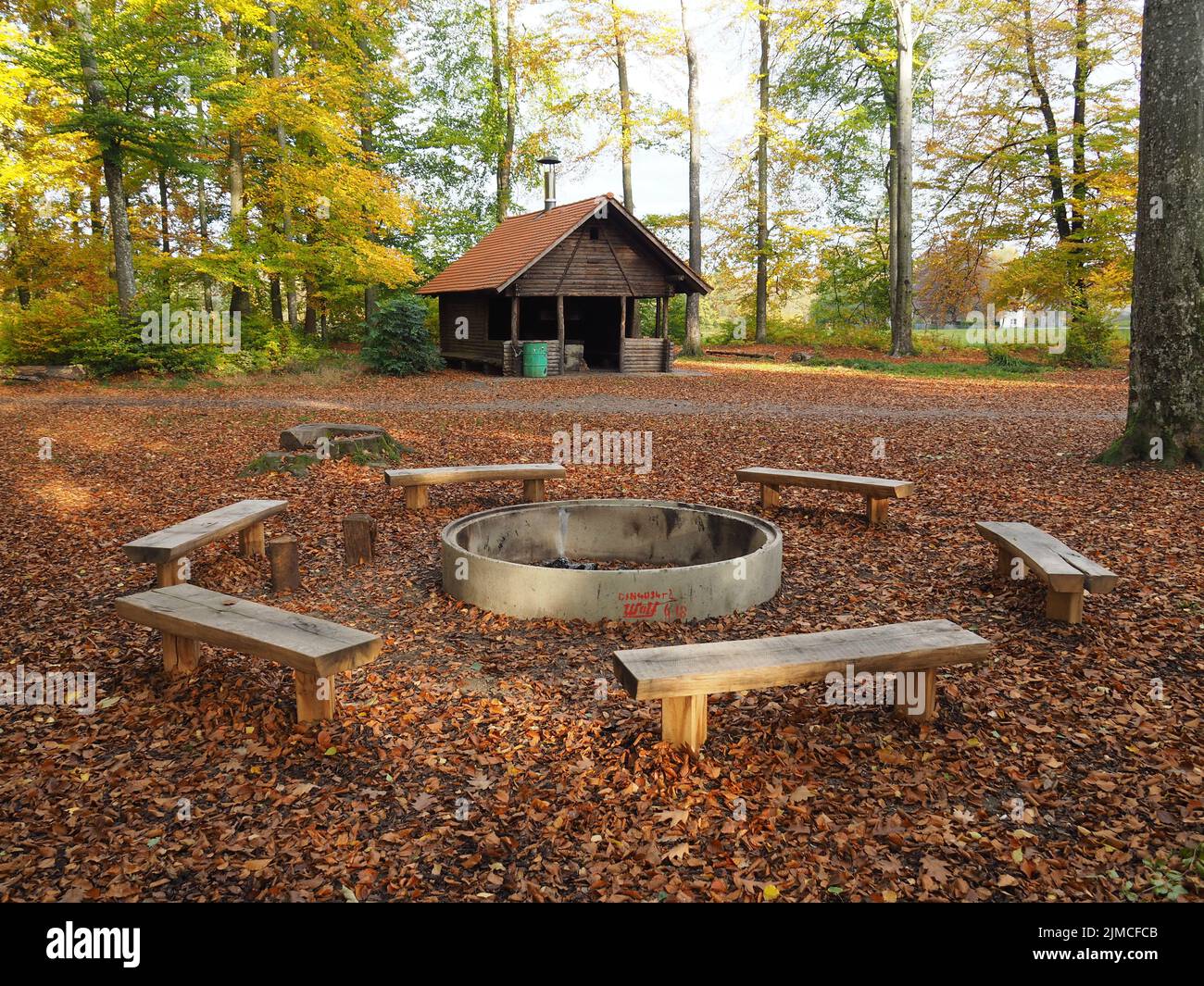 Barbecue hut and barbecue area with a fireplace and benches Stock Photo ...