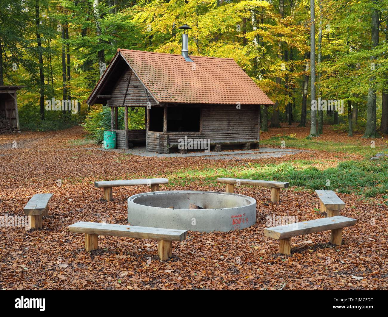 Barbecue hut and barbecue area with a fireplace and benches Stock Photo ...