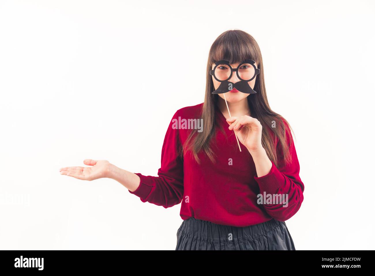 Woman with long straight brown hair covering her face with a fake paper ...