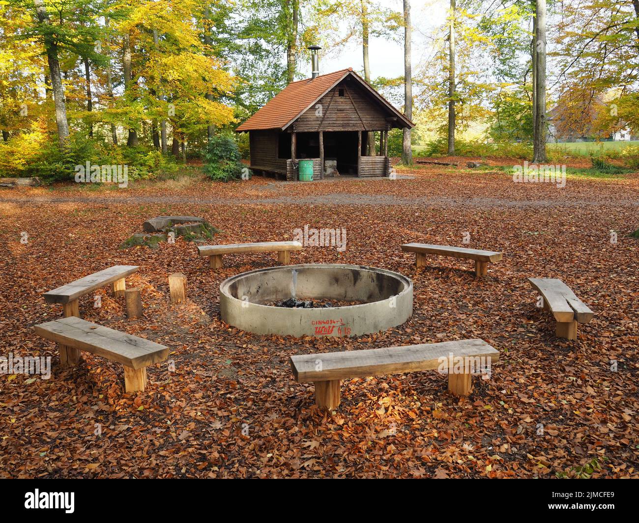 Barbecue hut and barbecue area with a fireplace and benches Stock Photo ...