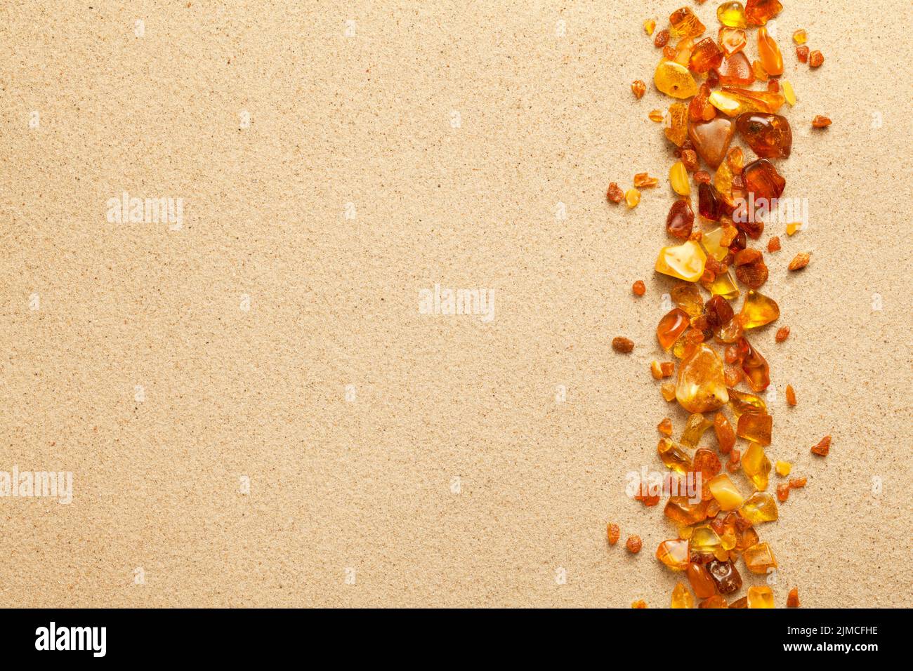 Ambers On Sand Background Stock Photo - Alamy