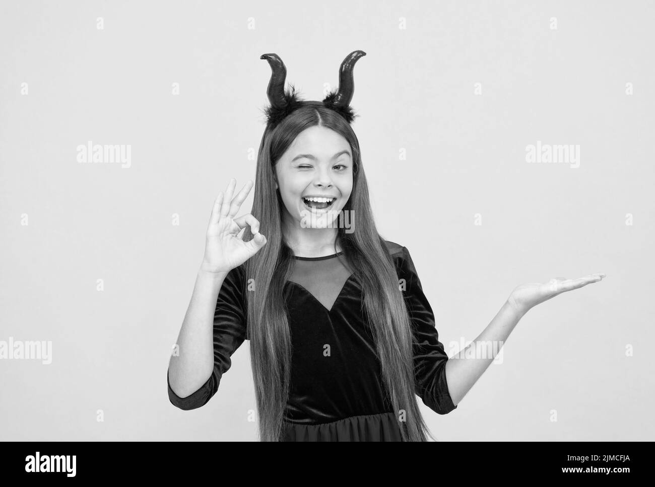 cunning little demon presenting product. halloween devil girl. happy ...