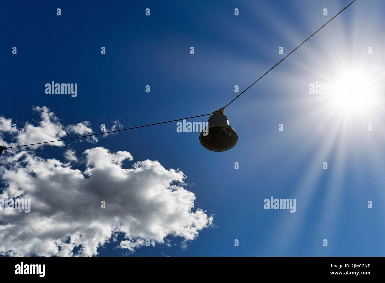 Single discarded bell hanging on steel cable, sound body, sound ...