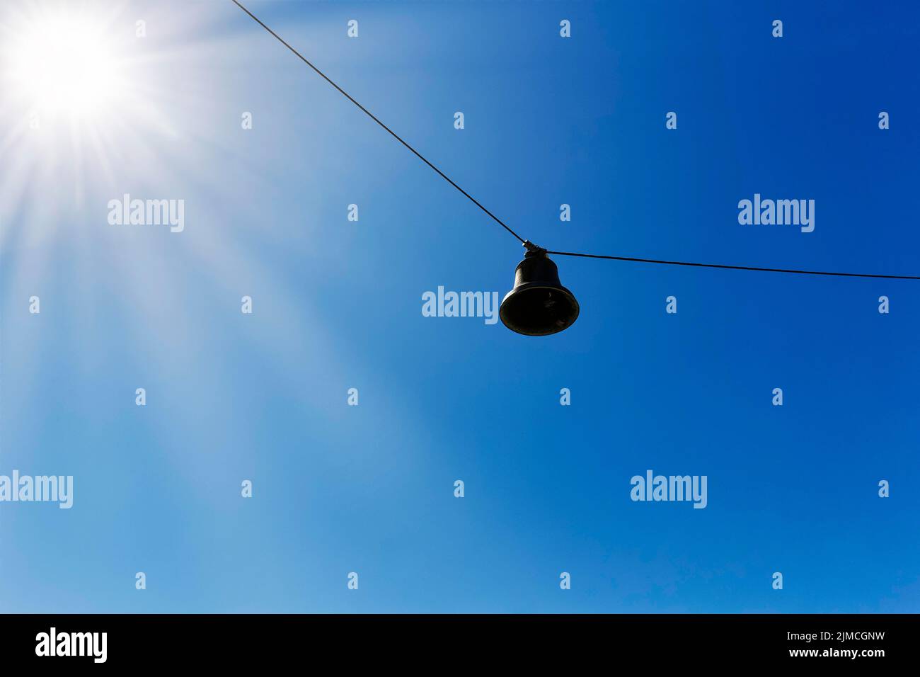 Single discarded bell hanging on steel cable, sound body, sound ...