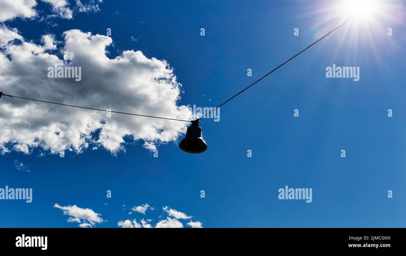Single discarded bell hanging on steel cable, sound body, sound ...