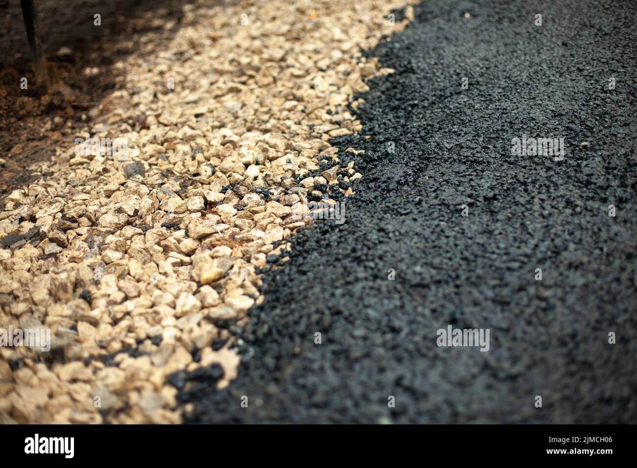 New asphalt. Construction of path in park. Details of road surface ...