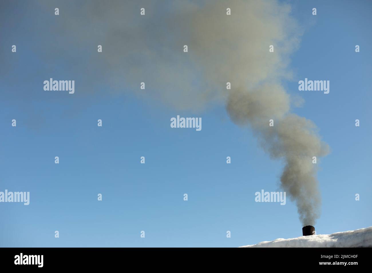 Smoke from chimney. Smoke in sky. Home heating. Pipe on roof of house ...