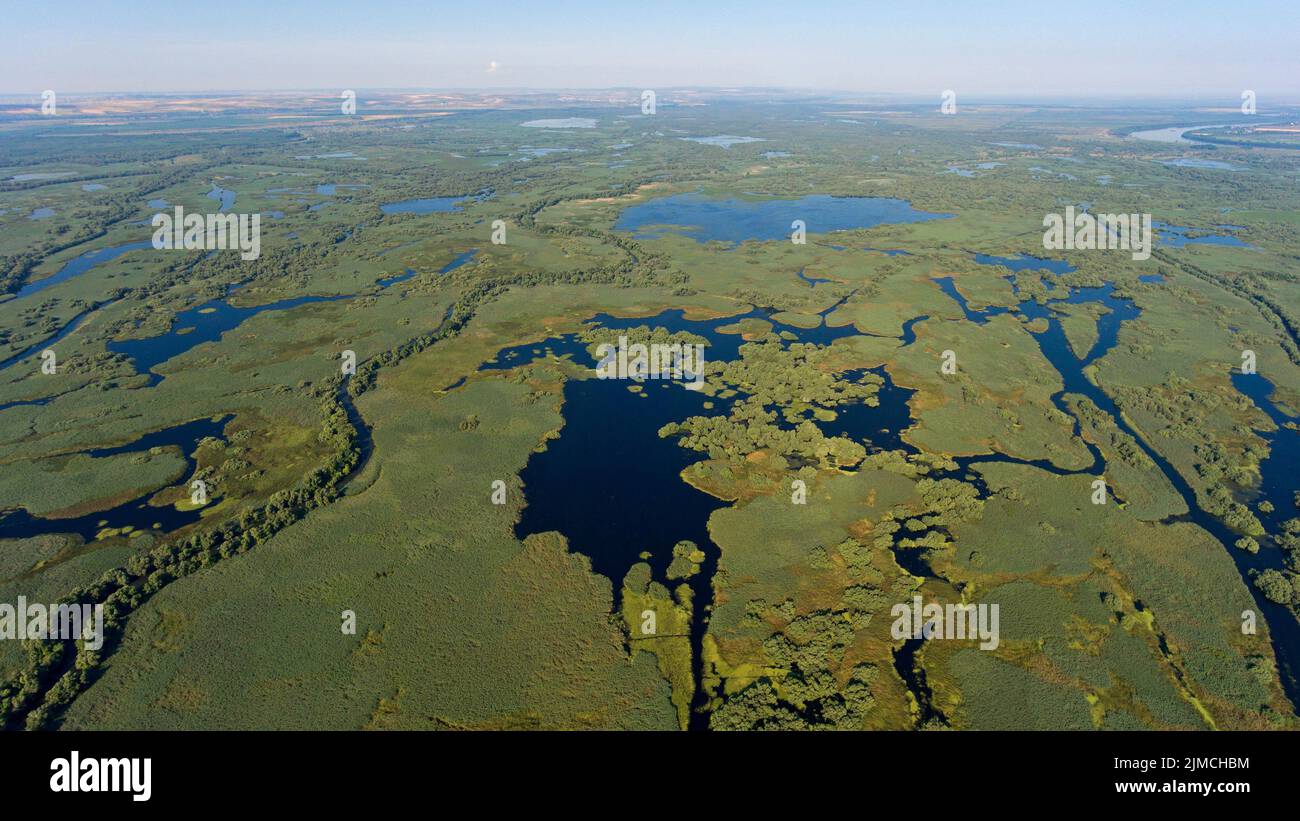 Danube River Delta, landscape with lakes, canals, reed beds, drone shot ...