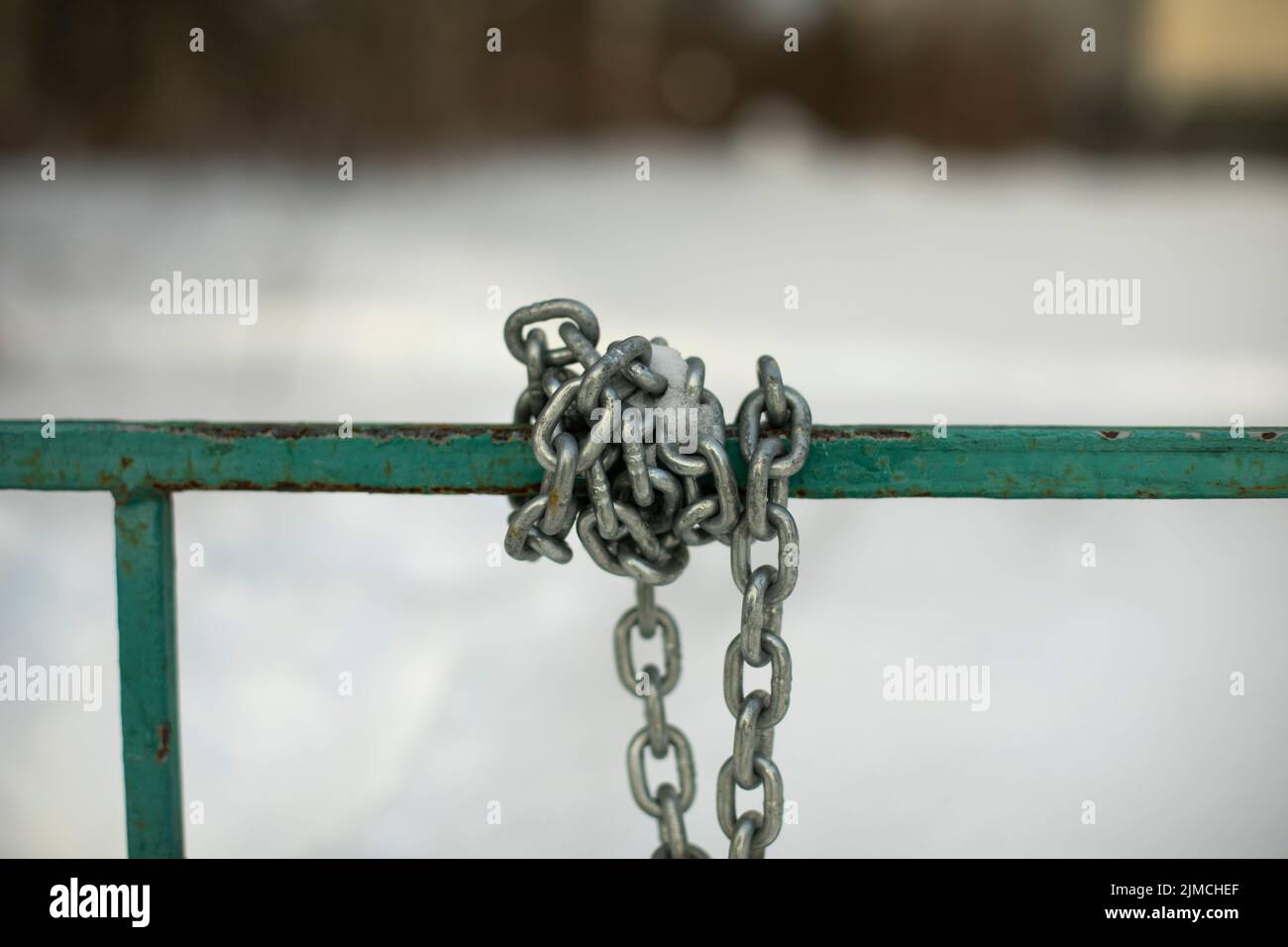 Steel chain is wound on handrail. Chain to protect bike. Links are ...