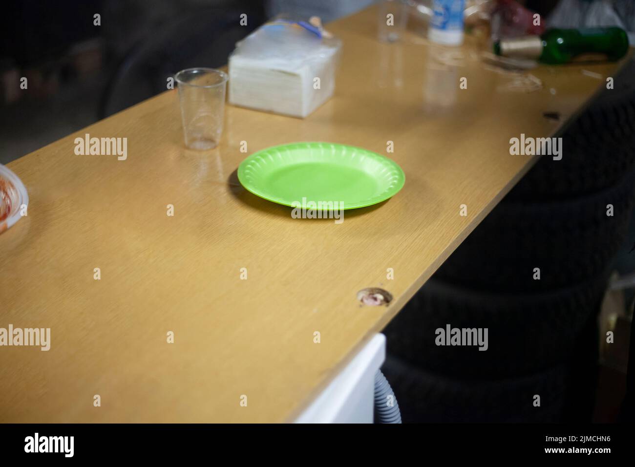 Plate on table. Dirt after party. Details of table with food in garage ...