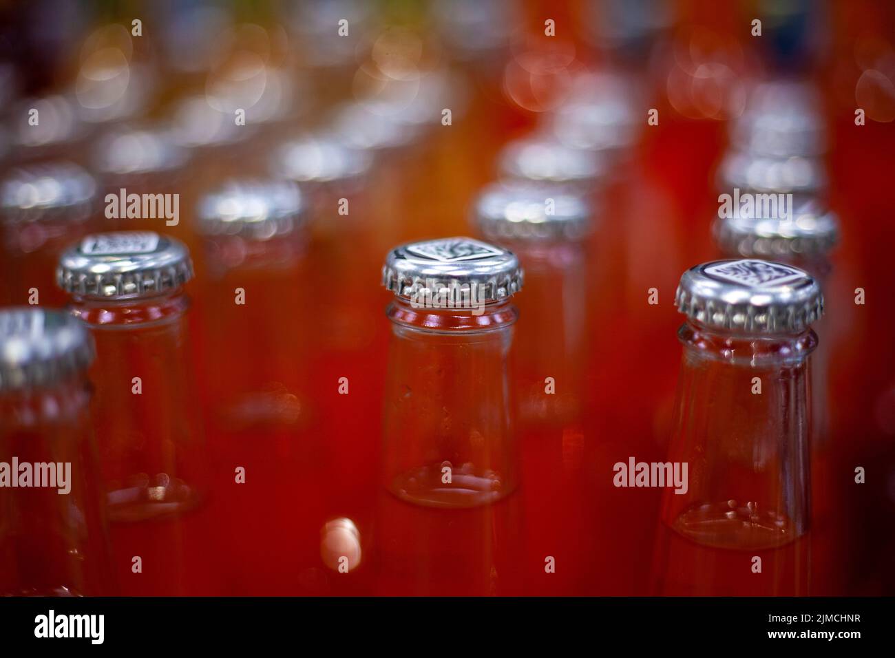 Bottled Alcohol. Drinks are in a row. Glass vessels with liquid. An ...