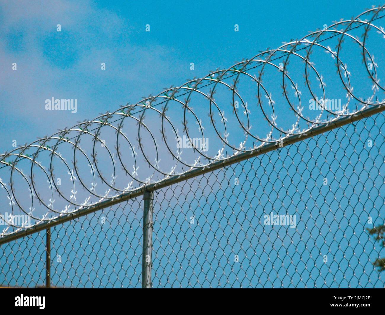 security fence above a standard high fence Stock Photo - Alamy