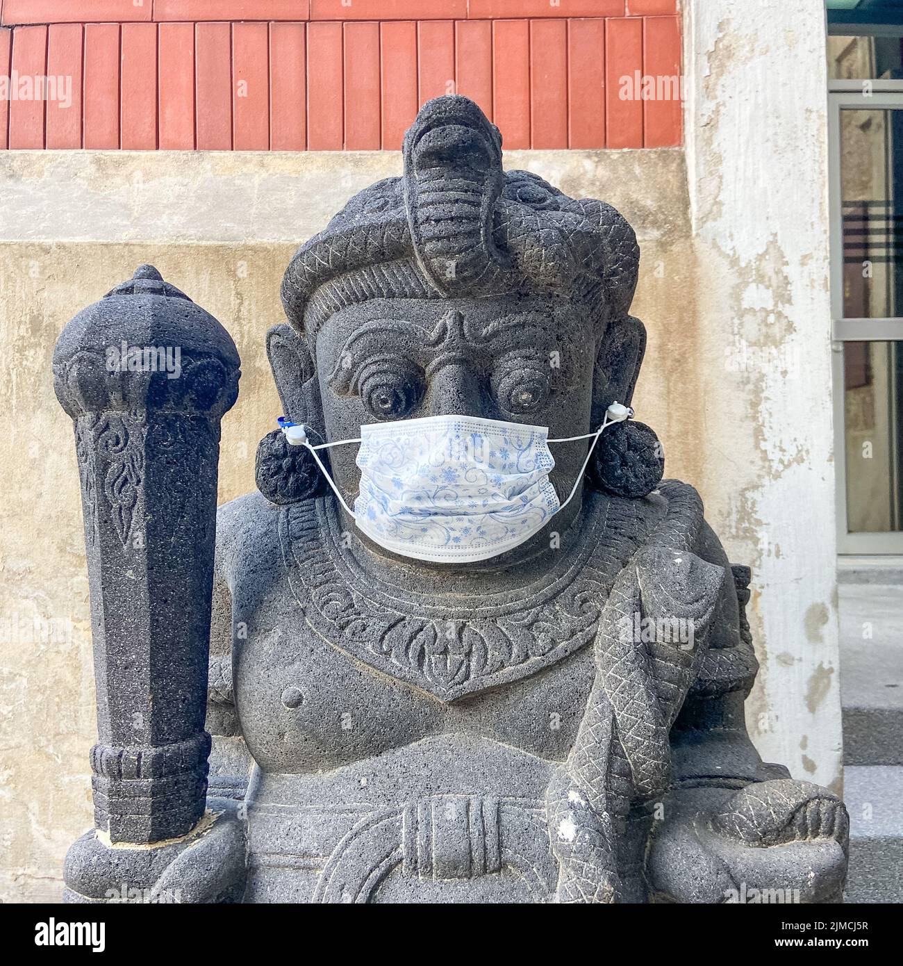 Traditional door guardian wearing a mask Stock Photo - Alamy