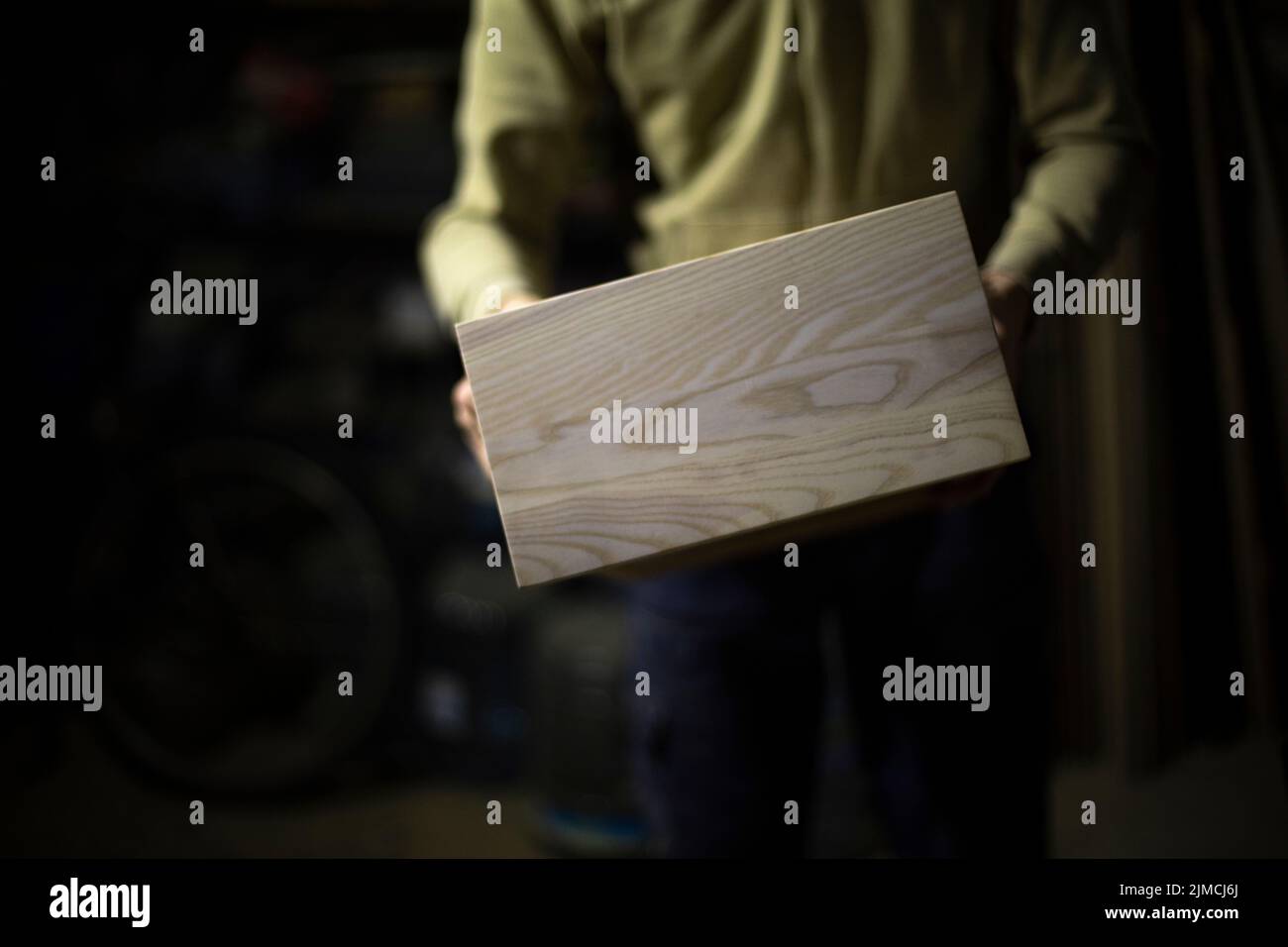 Box of wood in hand. Production of furniture from boards. Wooden ...