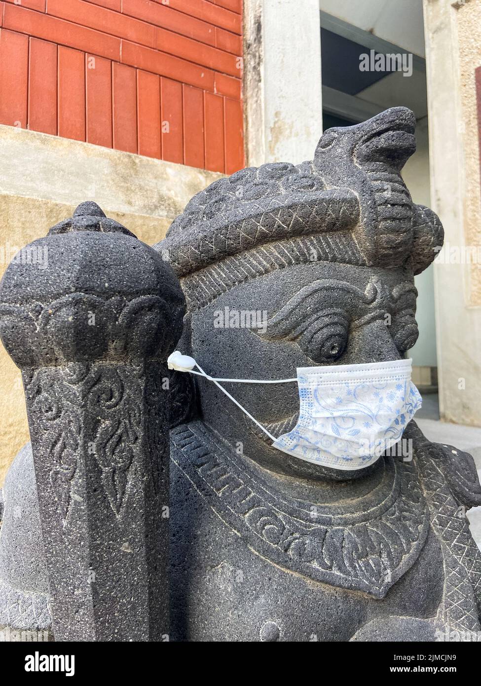 Covid-19 Javanese sculpture wearing facemask Stock Photo - Alamy