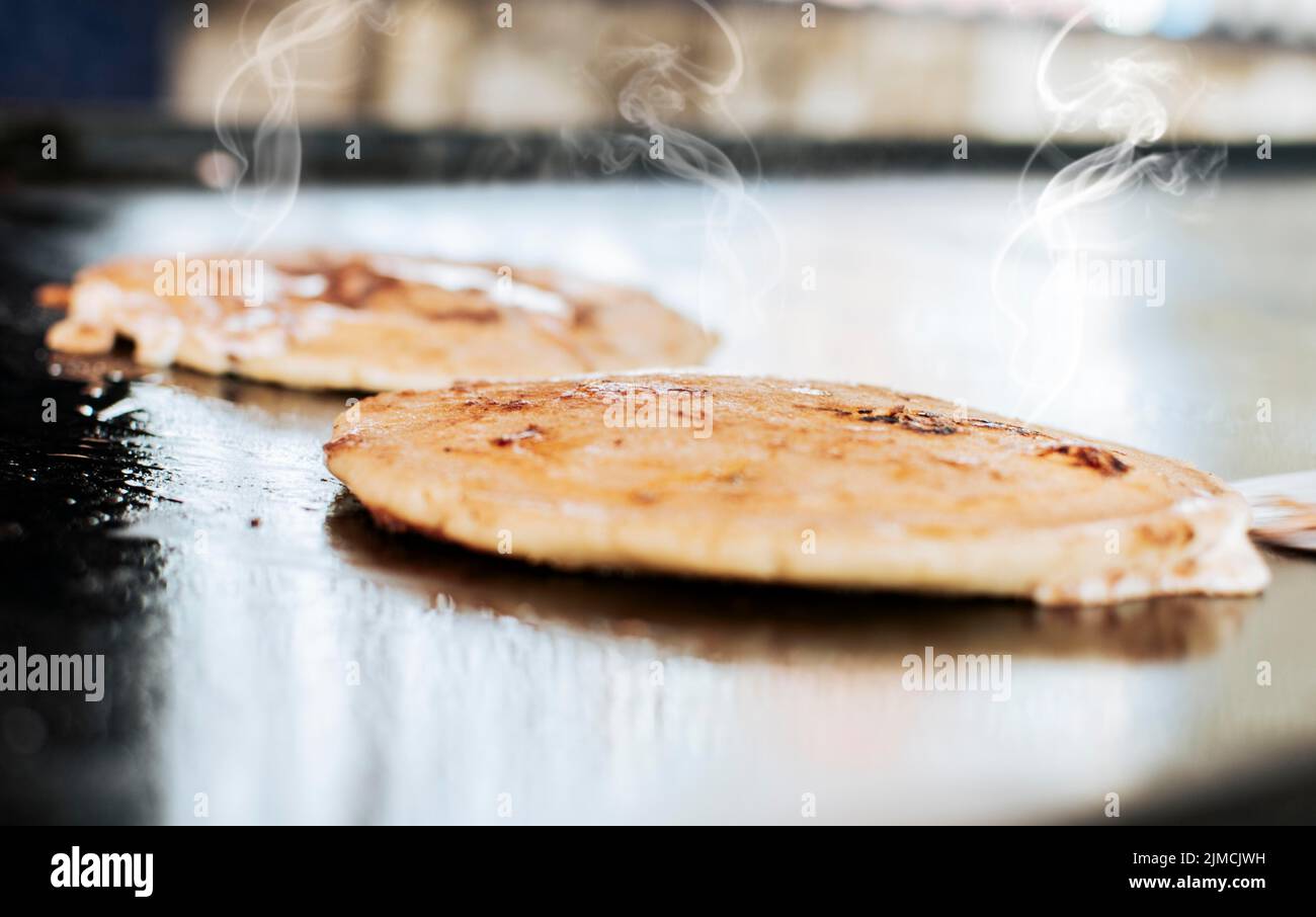 Close up of traditional handmade pupusas on grill, Traditional ...
