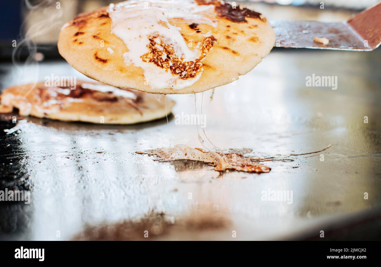 Traditional Nicaraguan Pupusas with melted cheese on grill. Traditional ...