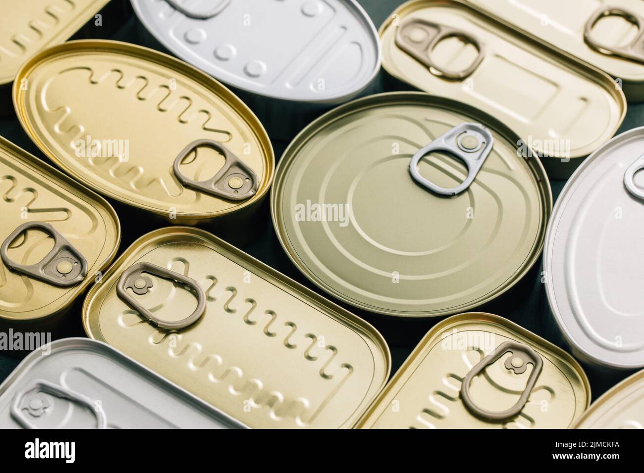 Top view row of different shapes of unopened cans Stock Photo - Alamy