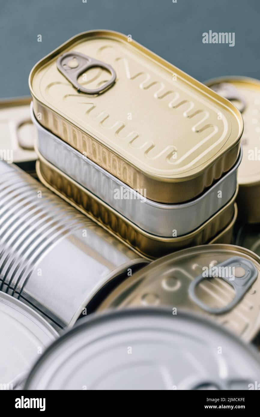 Top view row of unopened cans on a blue background Stock Photo - Alamy