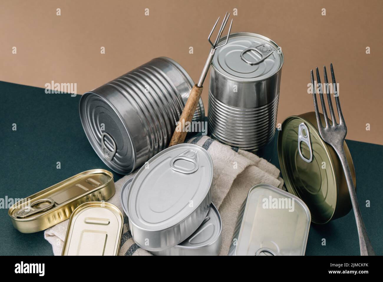 Stacked unopened cans on cloth on a brown and green background Stock ...